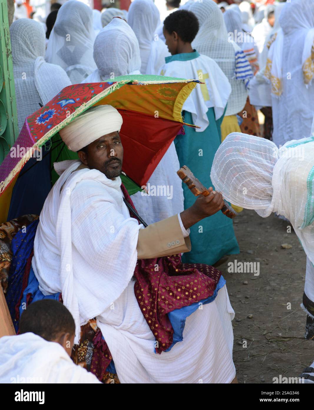 An Ethiopian Orthodox priest blessing worshippers at a local church ...