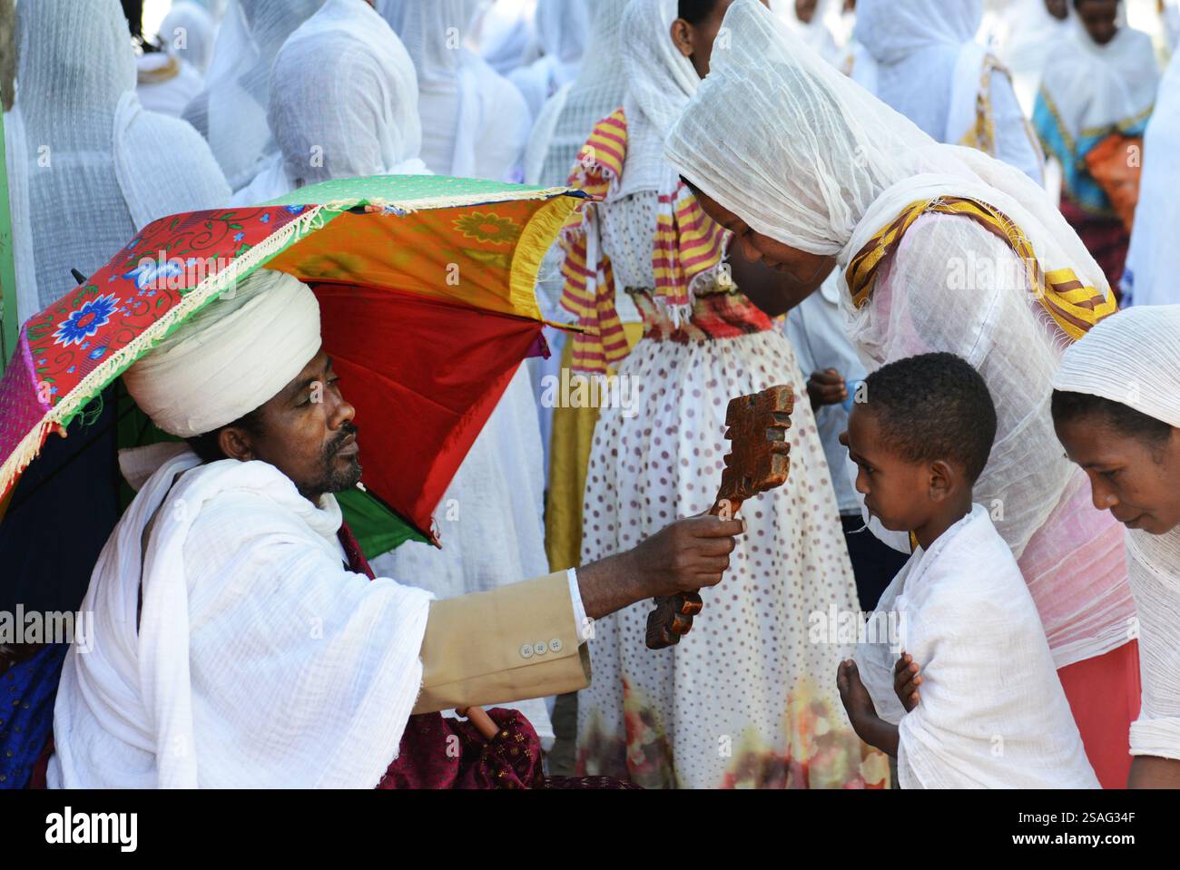 An Ethiopian Orthodox priest blessing worshippers at a local church ...