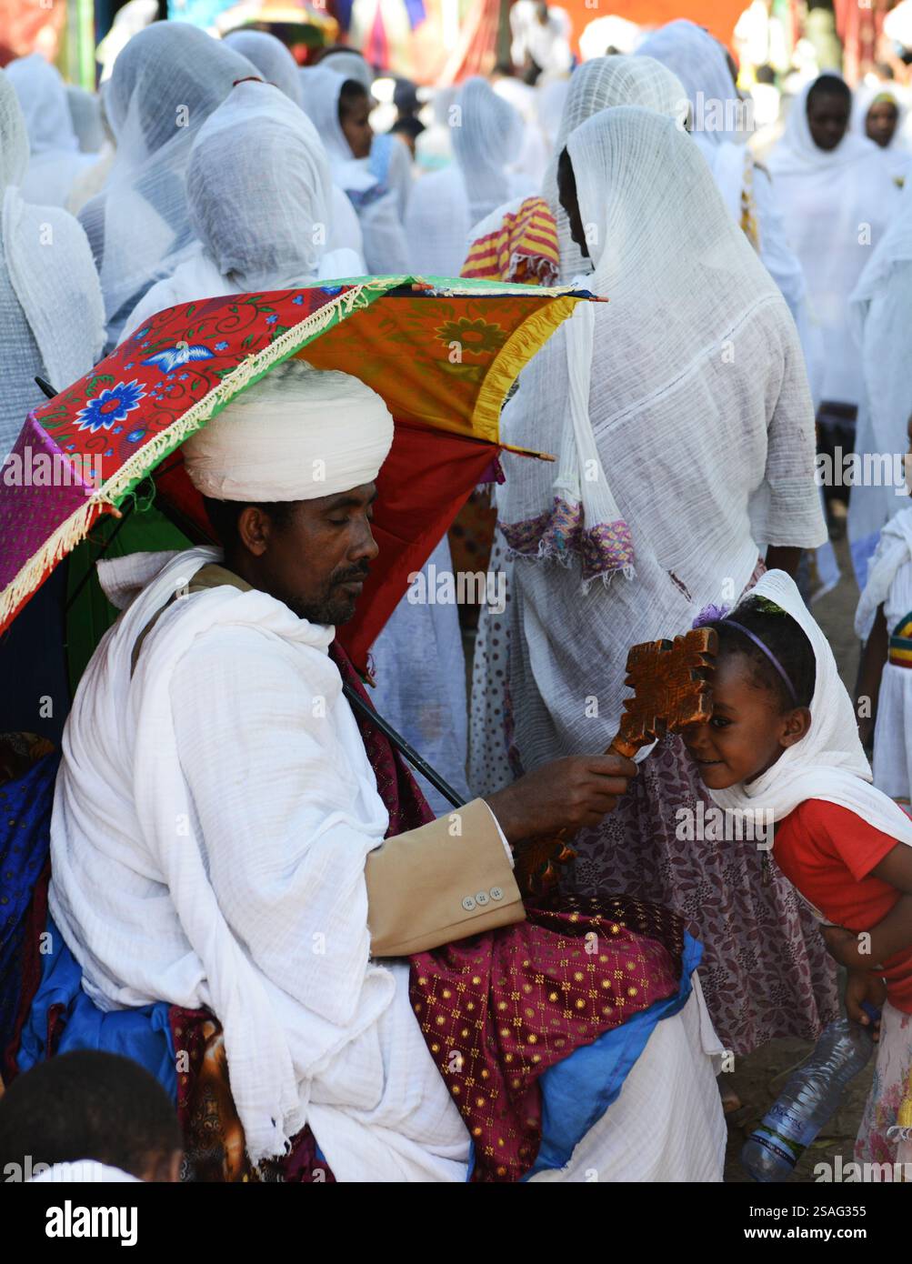 An Ethiopian Orthodox priest blessing worshippers at a local church ...