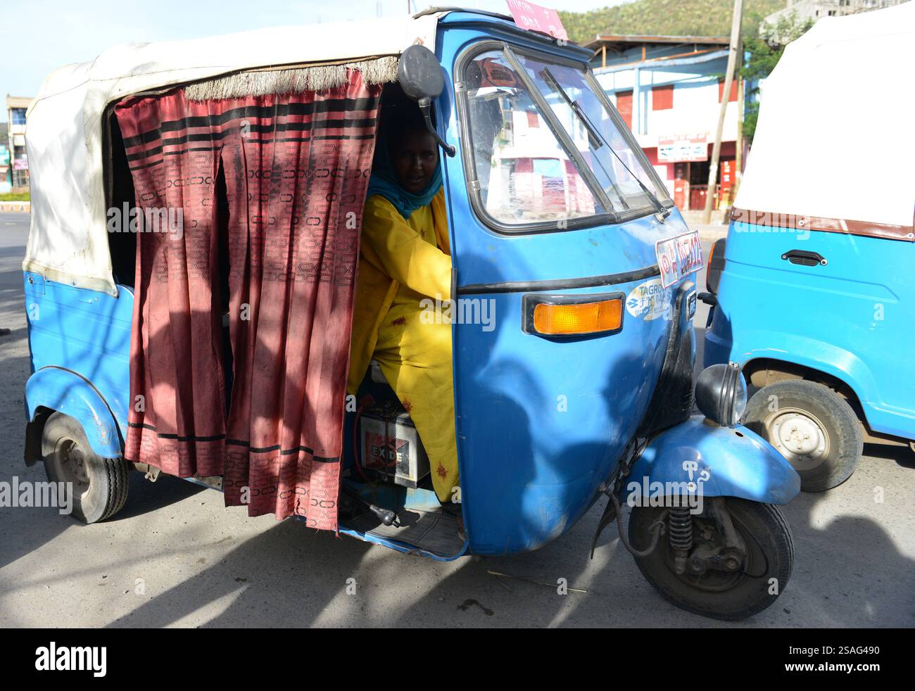 A female Ethiopian driver in her Auto Rickshaw in Kombolcha, Amhara ...