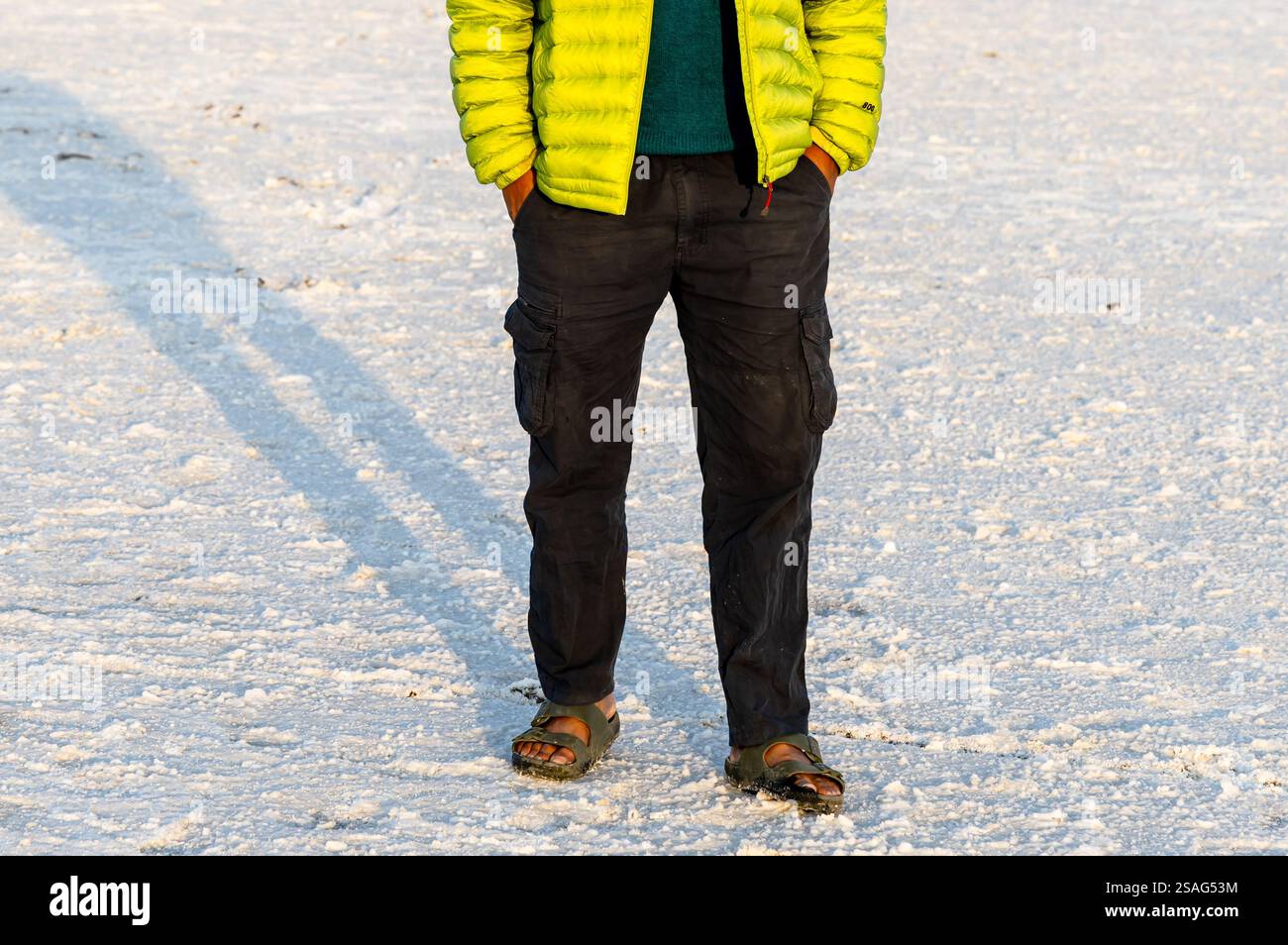 man walking foot view at remote white salt desert at morning from top ...