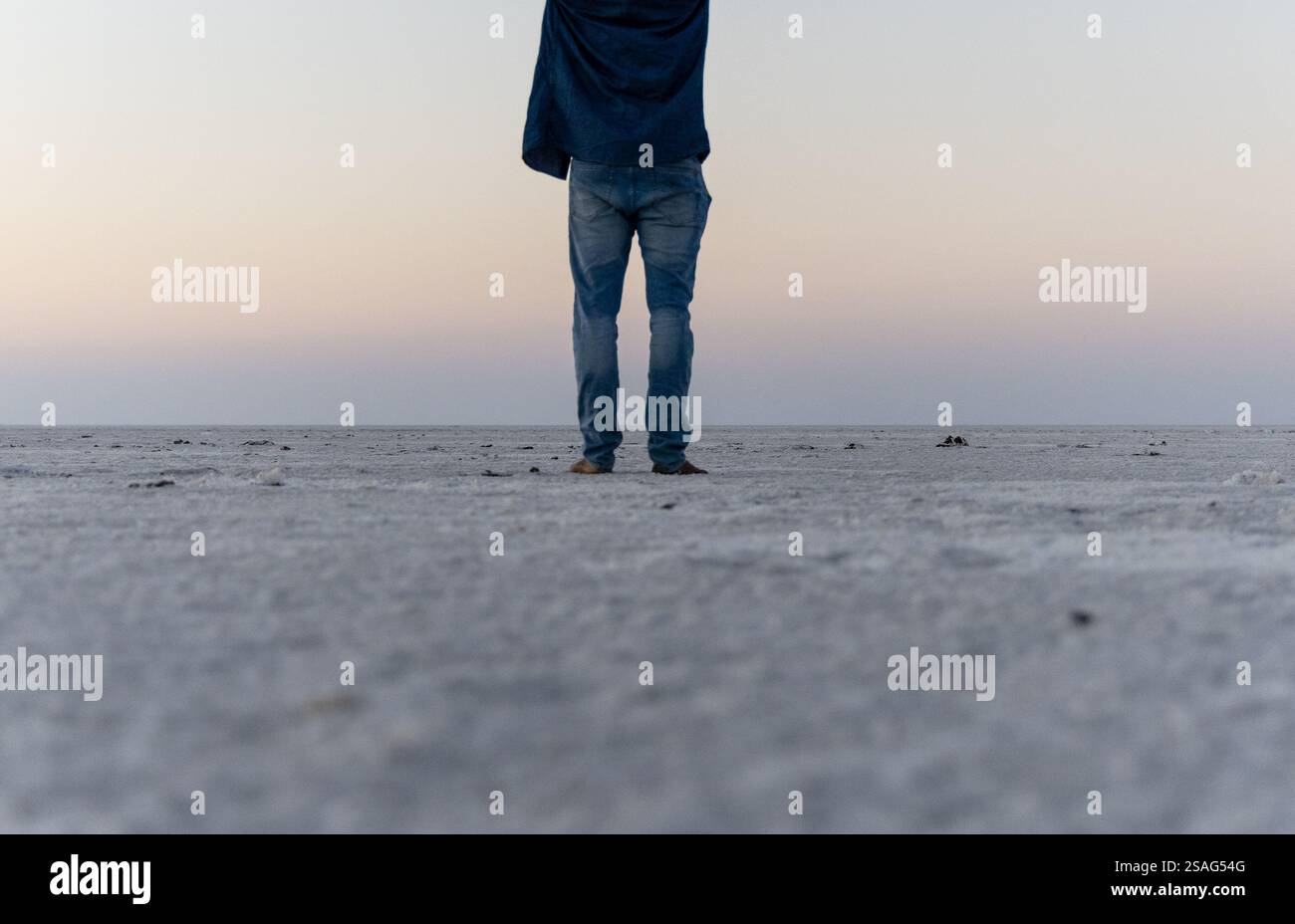 man walking foot view at remote white salt desert at morning from top ...