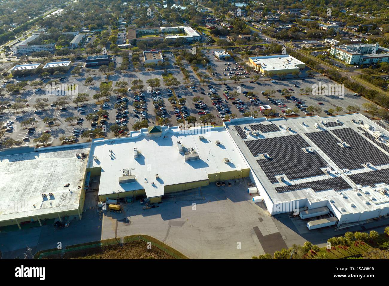 Aerial view of many cars parked on parking lot in front of a grocery ...