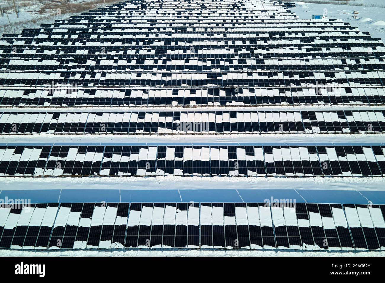 Aerial view of snow melting from covered solar photovoltaic panels at ...