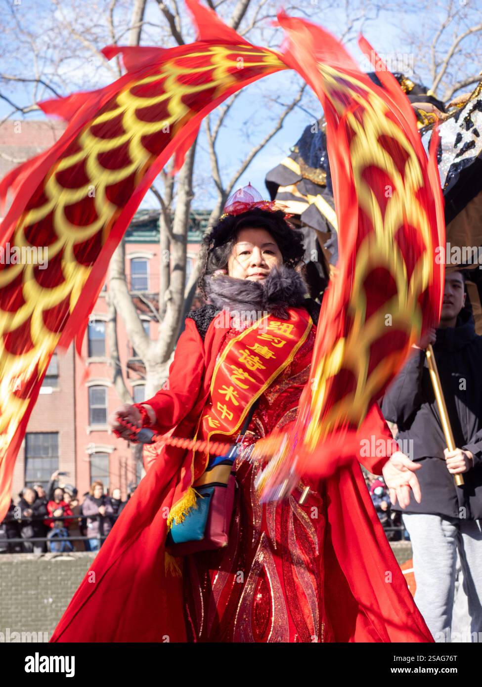 New York, New York, USA. 29th Jan, 2025. A woman swirls a ribbon of a ...