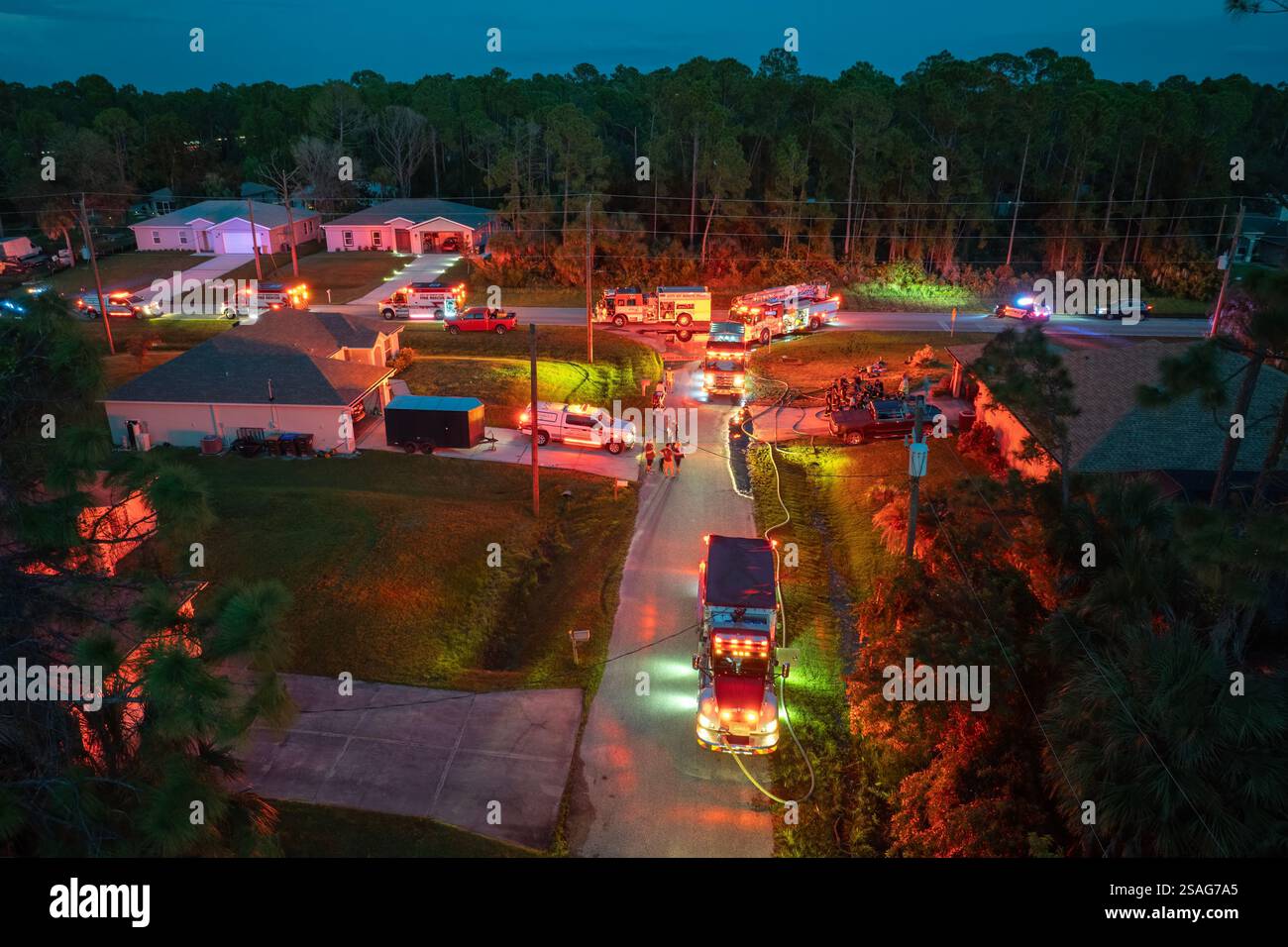 Firefighter trucks at fire alarm scene of suburban house. First ...