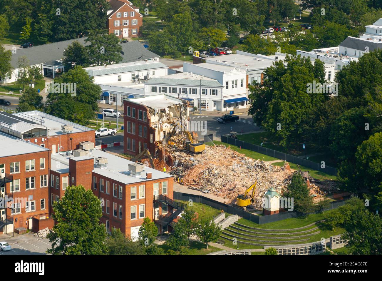 Old building demolition site. Construction excavator tearing down ...