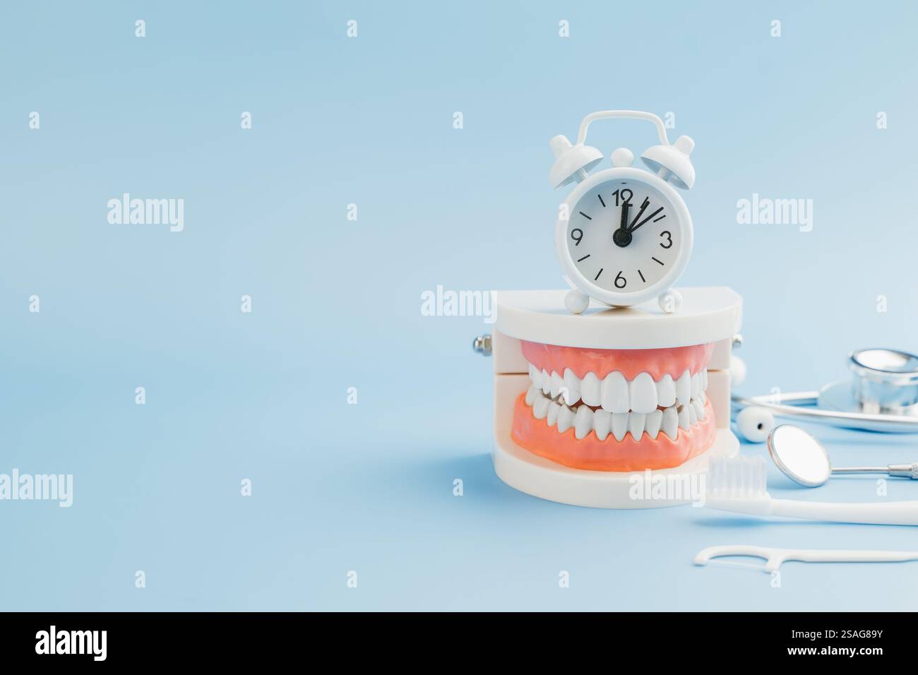 Dentist Day. A Dentist arranges a teeth model, stethoscope, tools, and ...