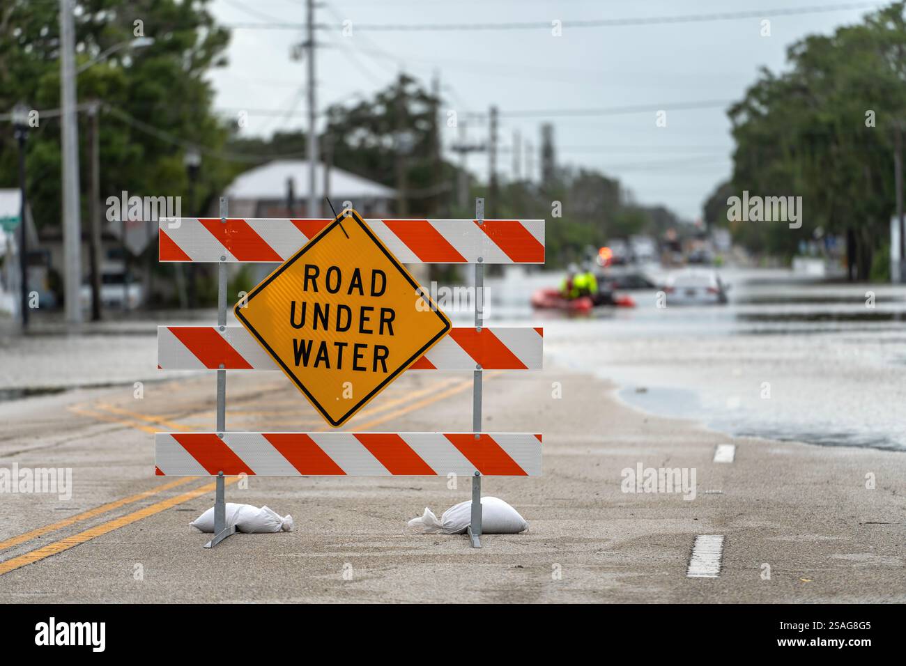Road closed because of flooding danger with warning signs blocking ...