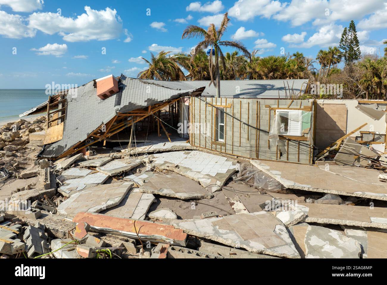 Ruined buildings in need of demolition or repair. Storm surge water and ...