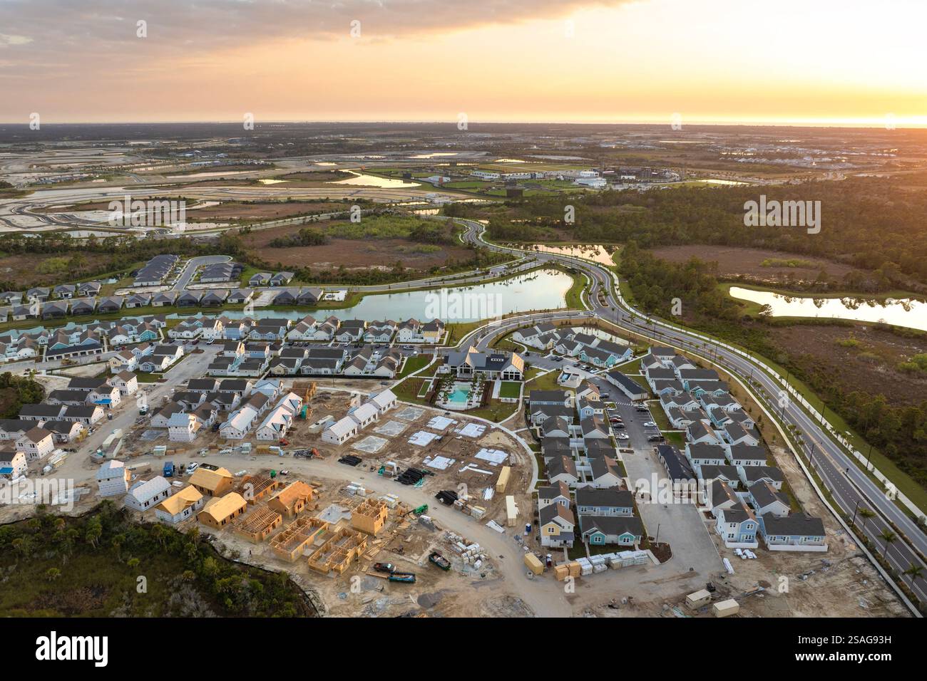 Unfinished frames of inexpensive homes with wooden roof beams under ...