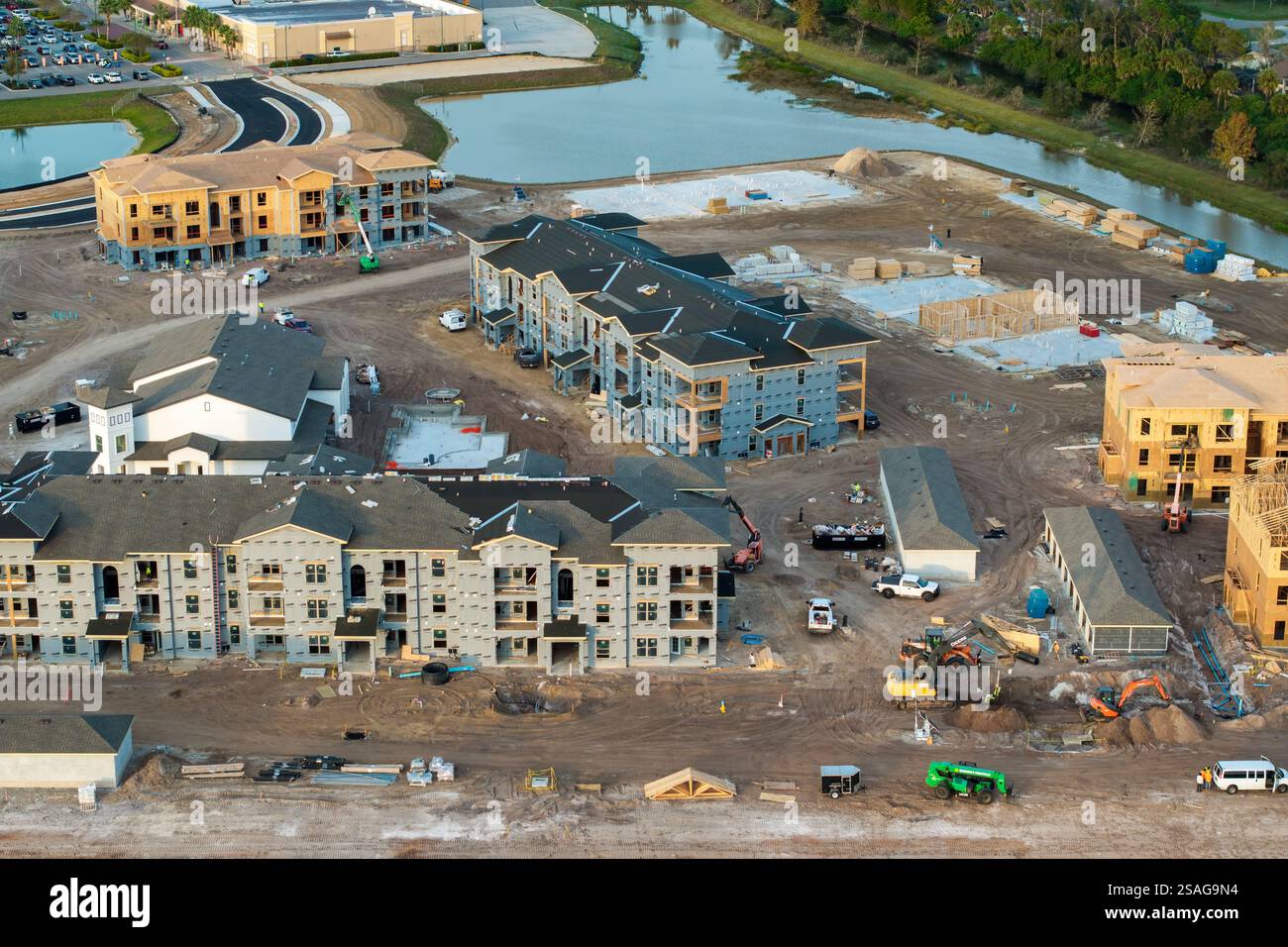 Wooden apartment buildings under construction in new developing ...