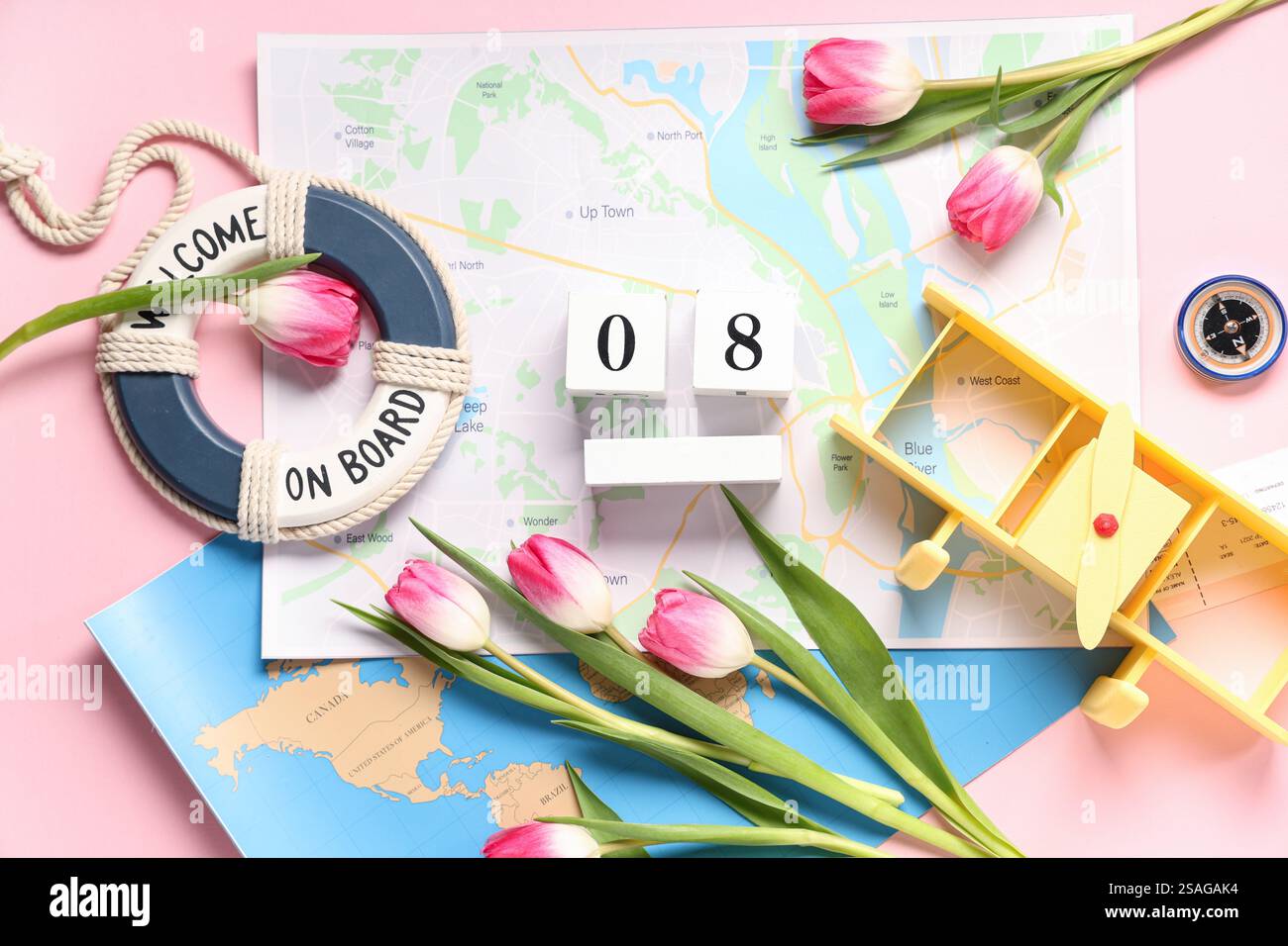 Composition with world maps, toy plane, ticket and flowers for ...