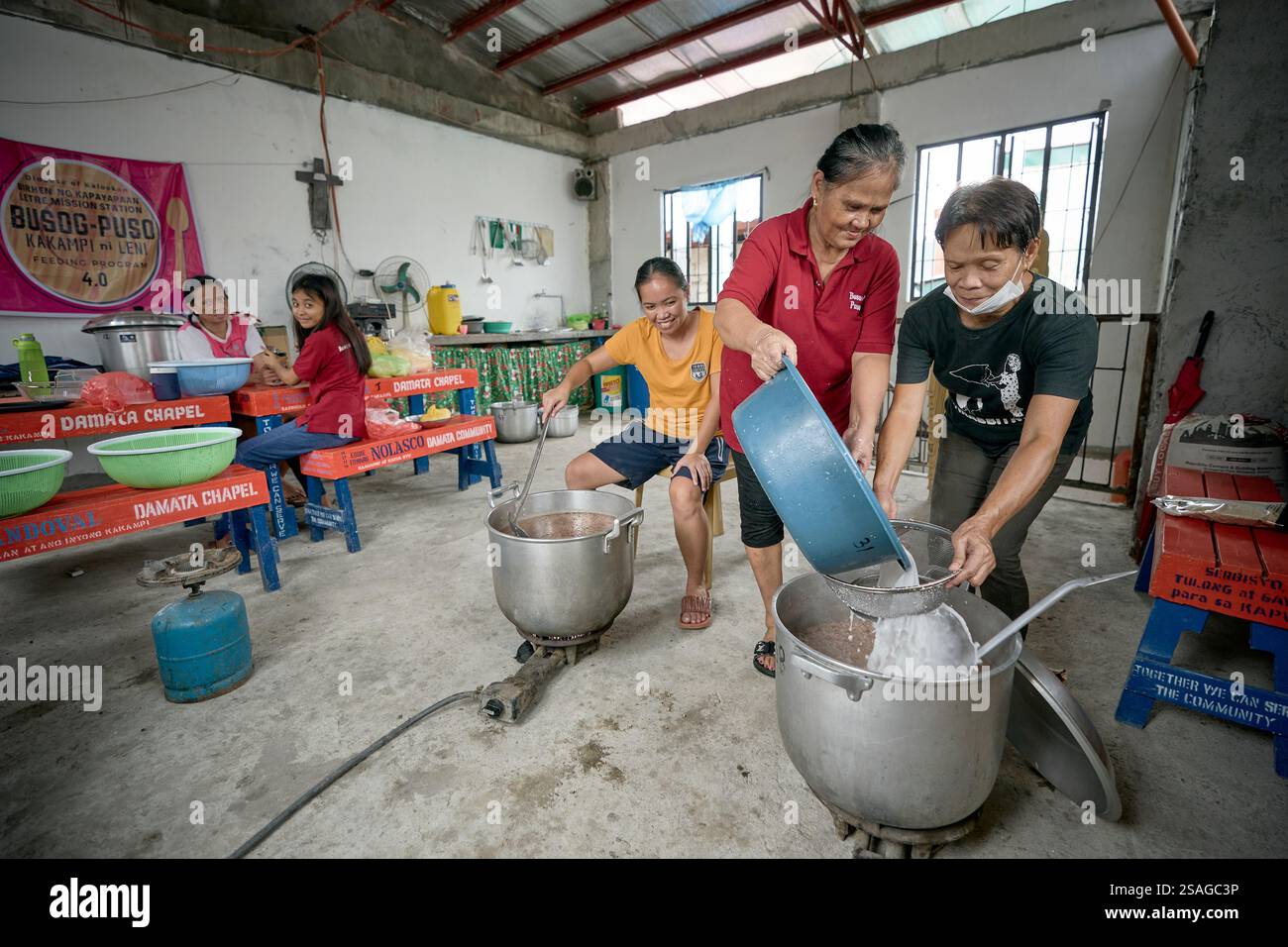 Women cook rice and beans in a feeding program for children in a poor ...