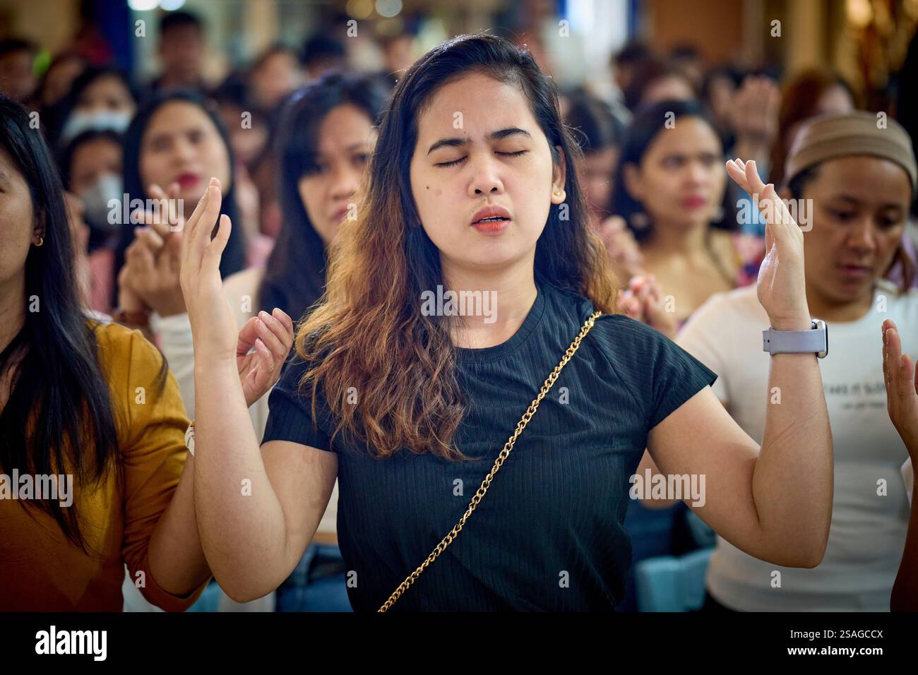 Migrant workers from the Philippines participate in Mass at the Tanzi ...