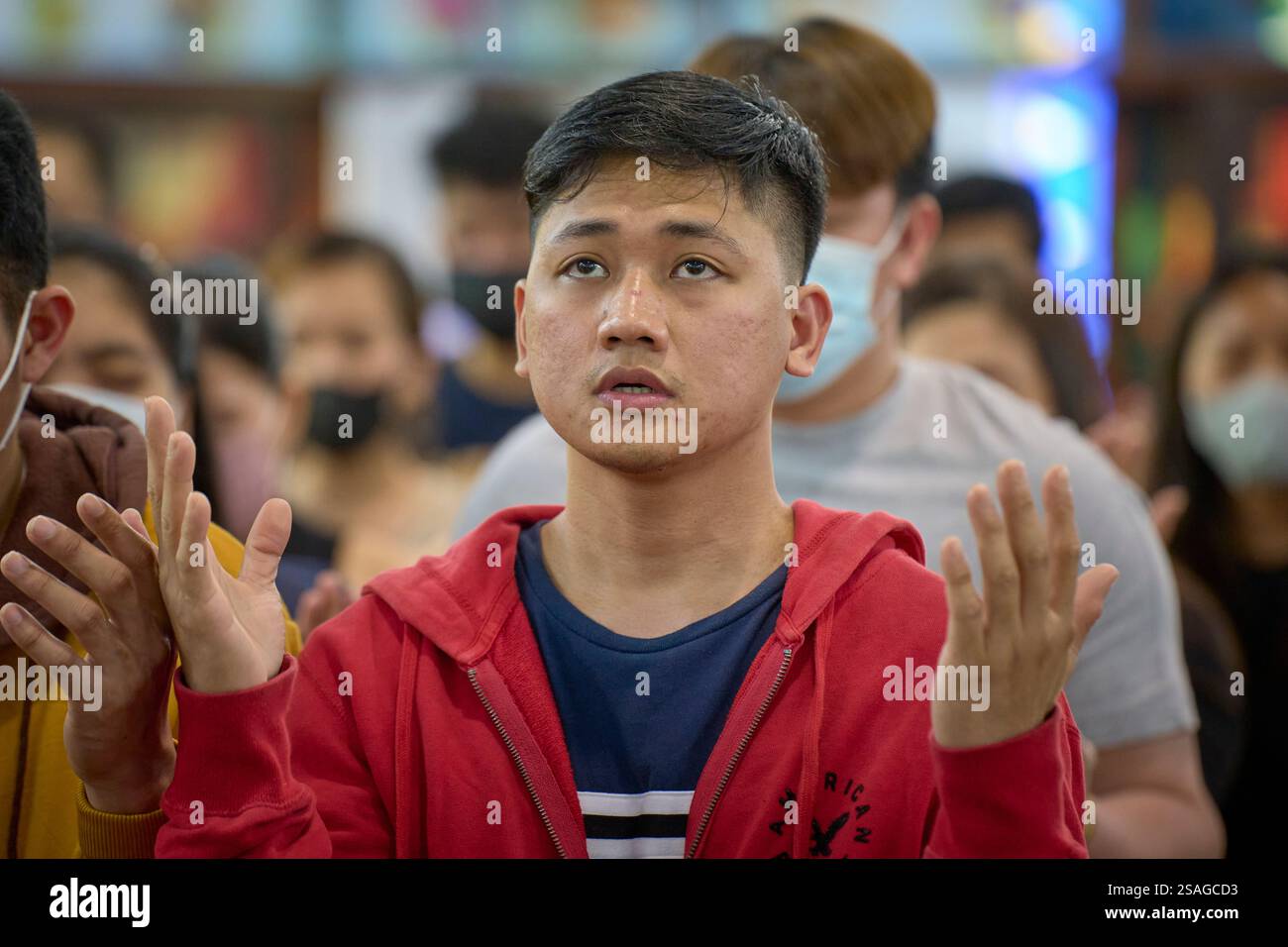 A migrant worker from the Philippines participates in Mass at the ...