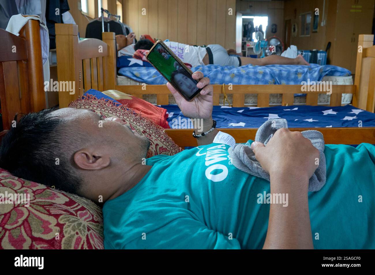 Charlie Cabasa, a migrant worker from the Philippines, talks to his ...