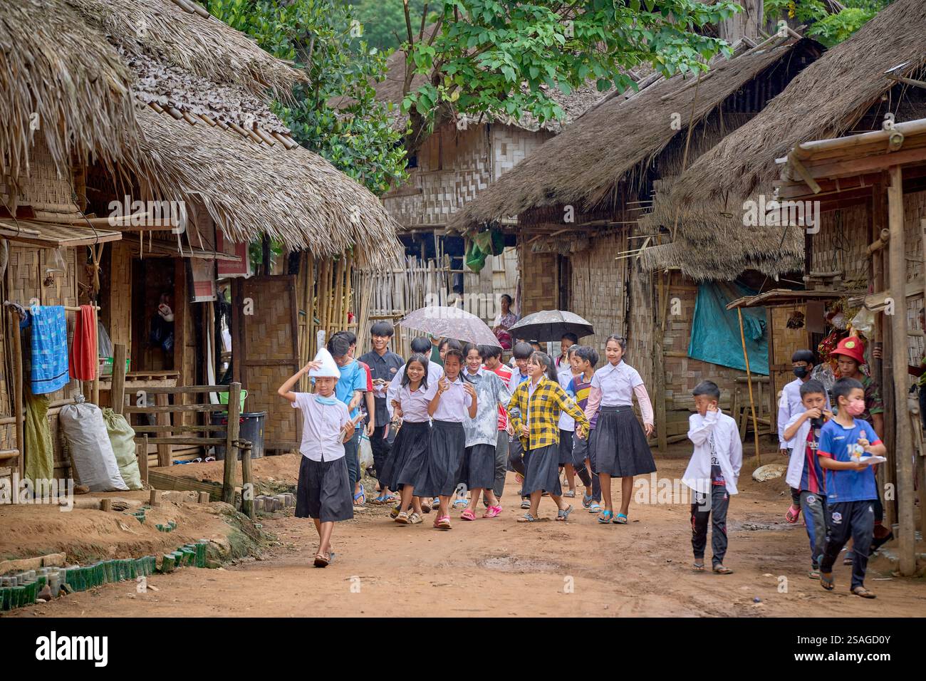 Children walk along a street in the Ban Mai Nai Soi refugee camp in ...