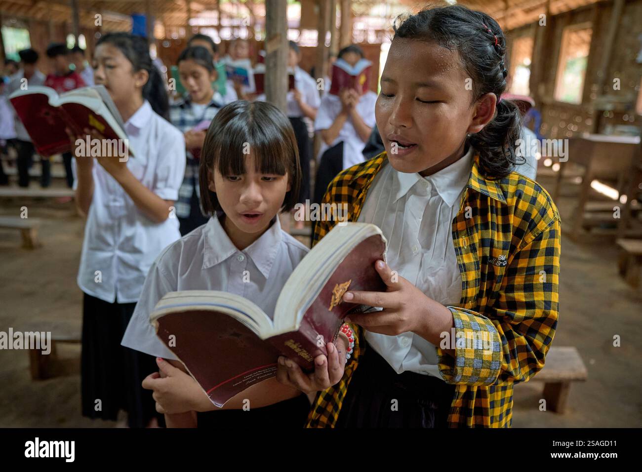 Children sing and pray in St. Mary's Catholic Church in the Ban Mai Nai ...