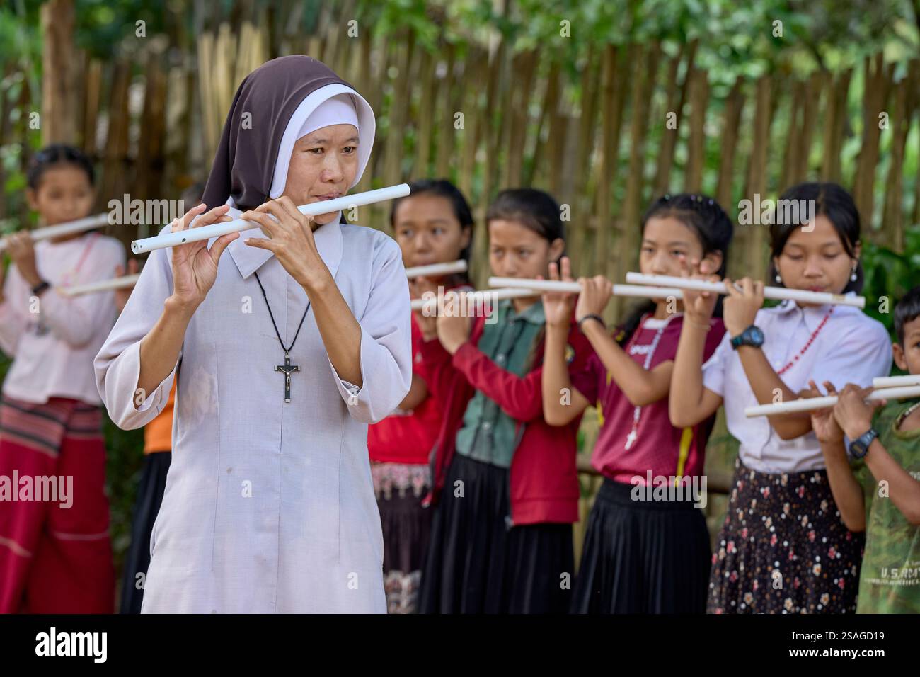 Burmese Sister Stella Pie Pi Moe teaches children to play the flute in ...