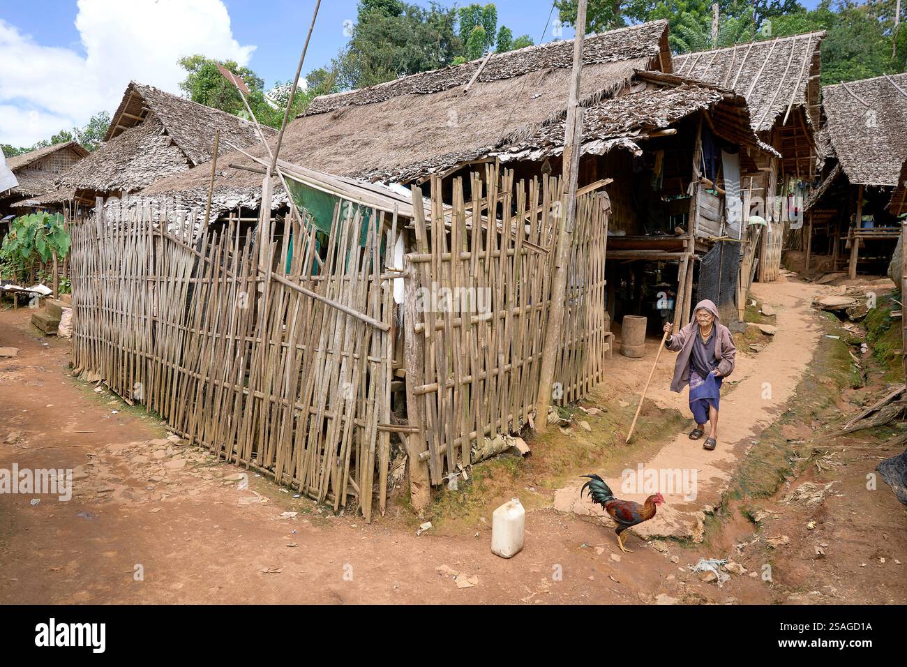 An old woman walks in the Ban Mai Nai Soi refugee camp in Thailand. The ...