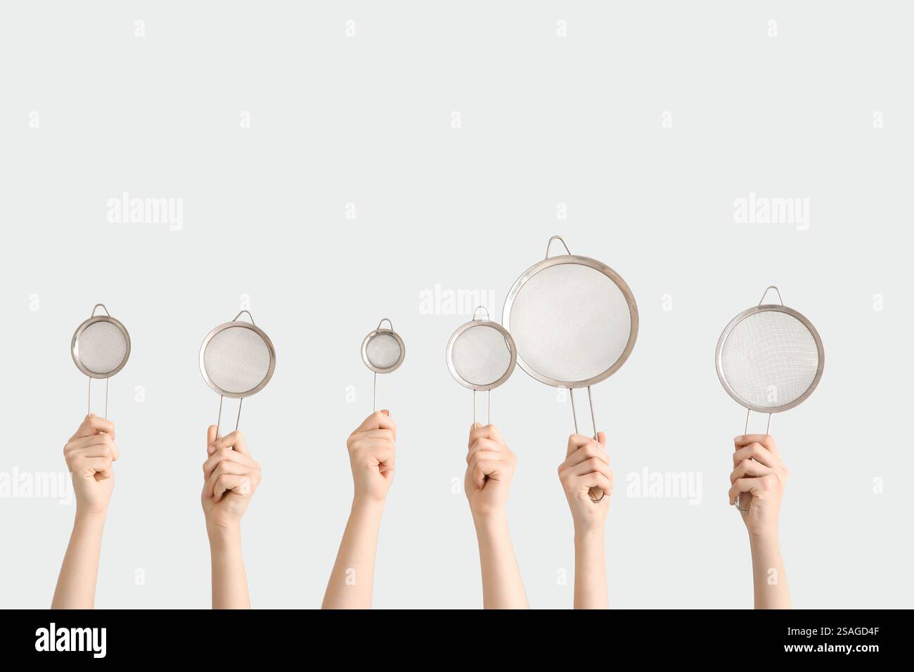Female hands with sieves on white background Stock Photo - Alamy