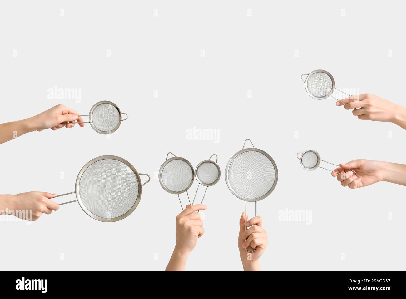 Female hands with sieves on white background Stock Photo - Alamy