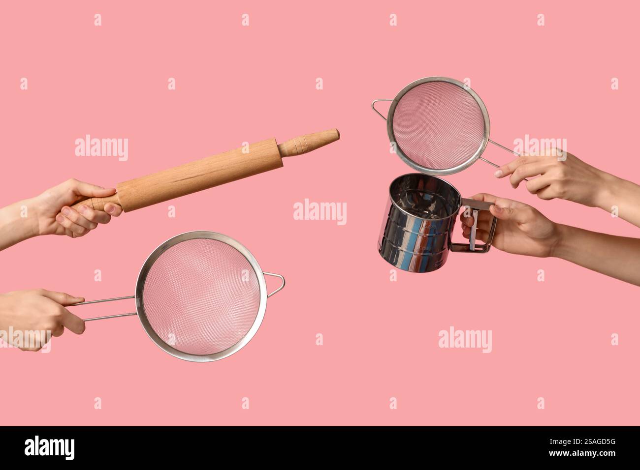Female hands holding sieves with rolling pin on pink background Stock ...