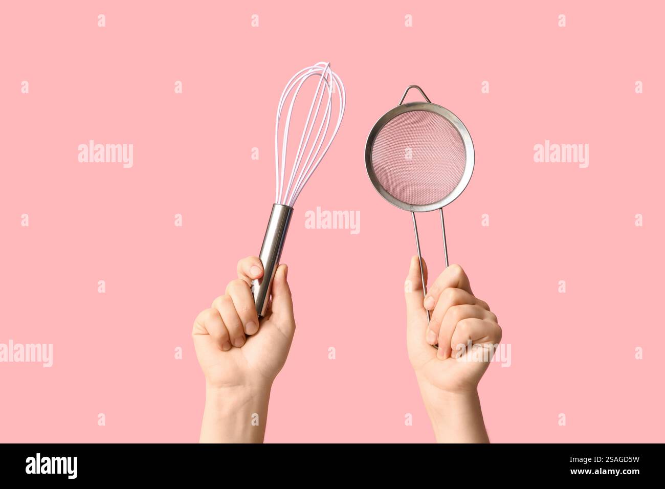 Female hands with sieve and whisk on pink background Stock Photo - Alamy