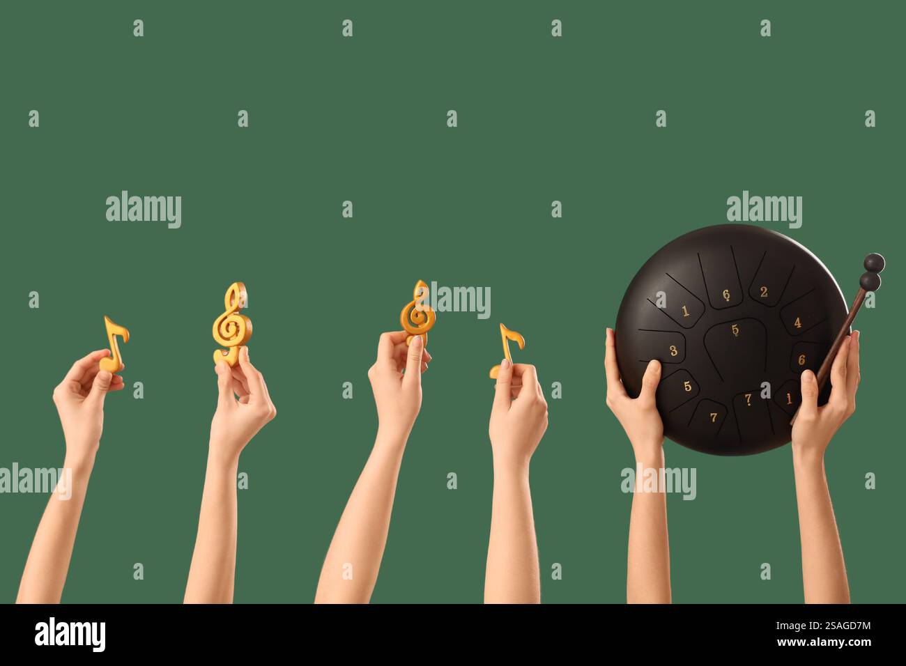 Female hands holding glucophone and music notes on dark green ...