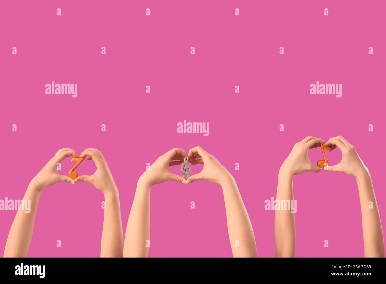 Female hands making hearts and holding music notes on pink background ...