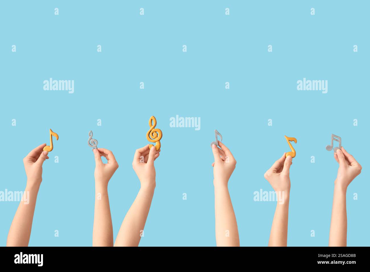 Female hands with music notes and treble clefs on blue background Stock ...
