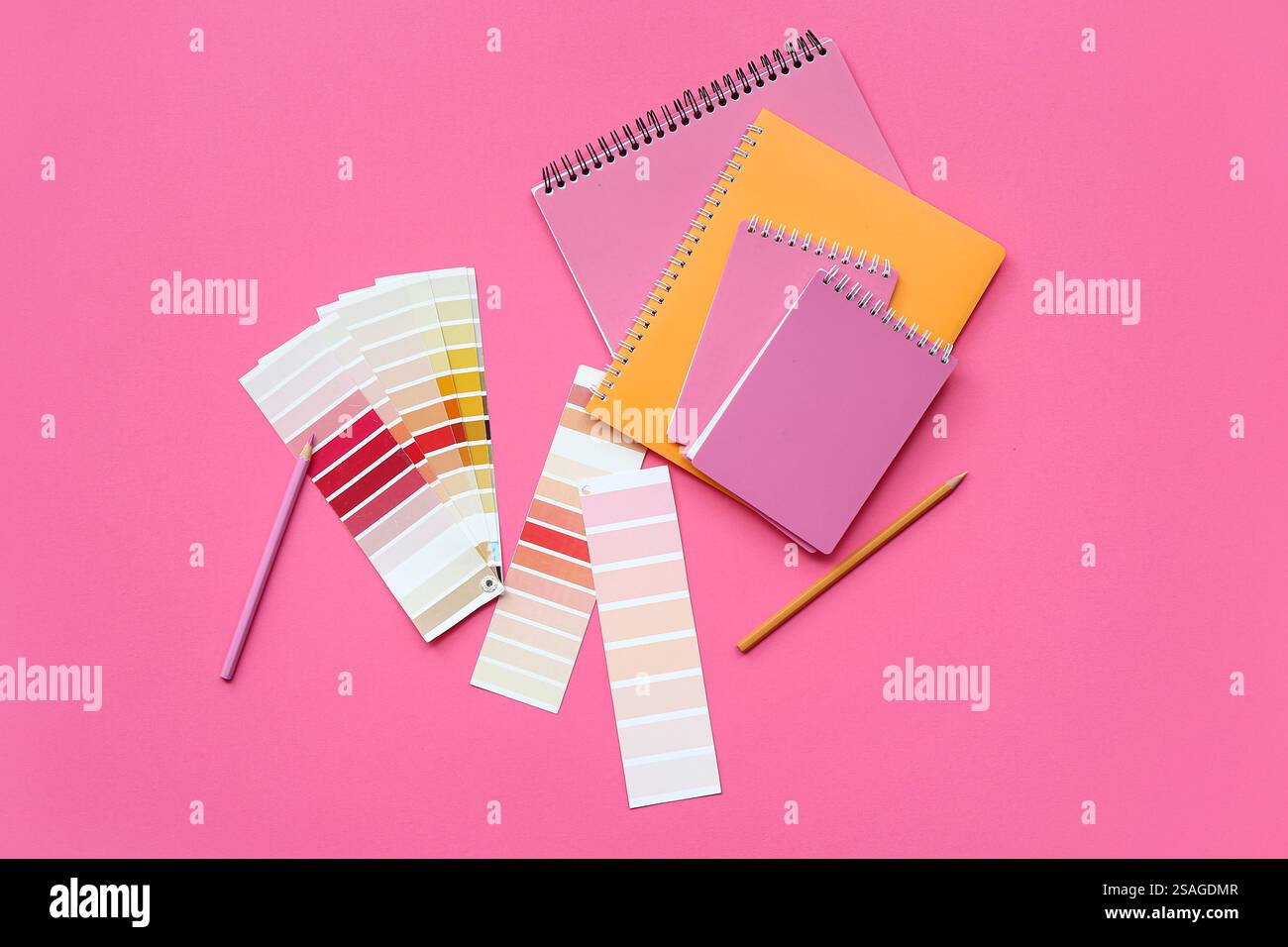 Composition with different notebooks, paint color palettes and pencils ...