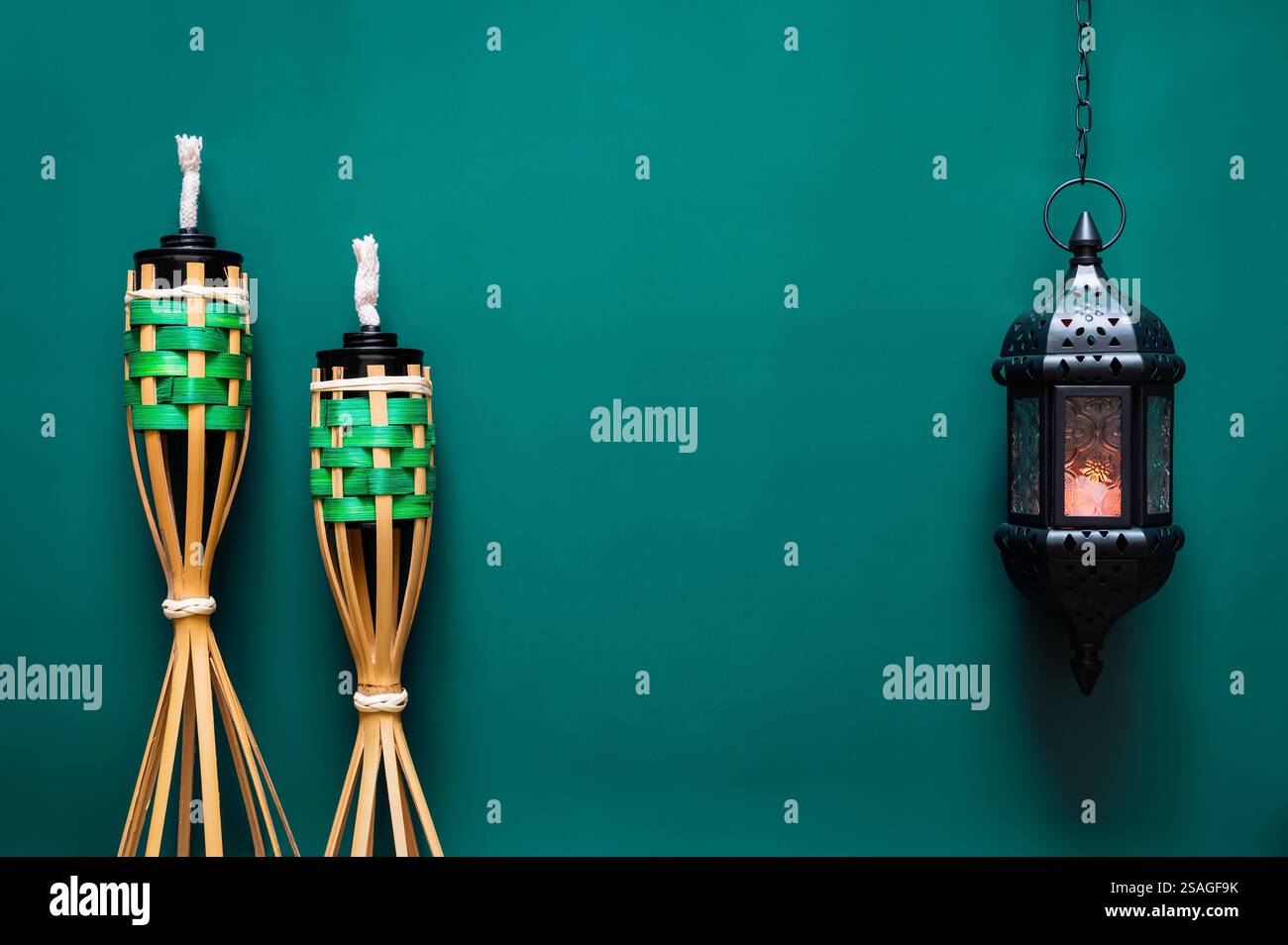 Pelita or know as oil lamp with hanging lantern on green background for ...