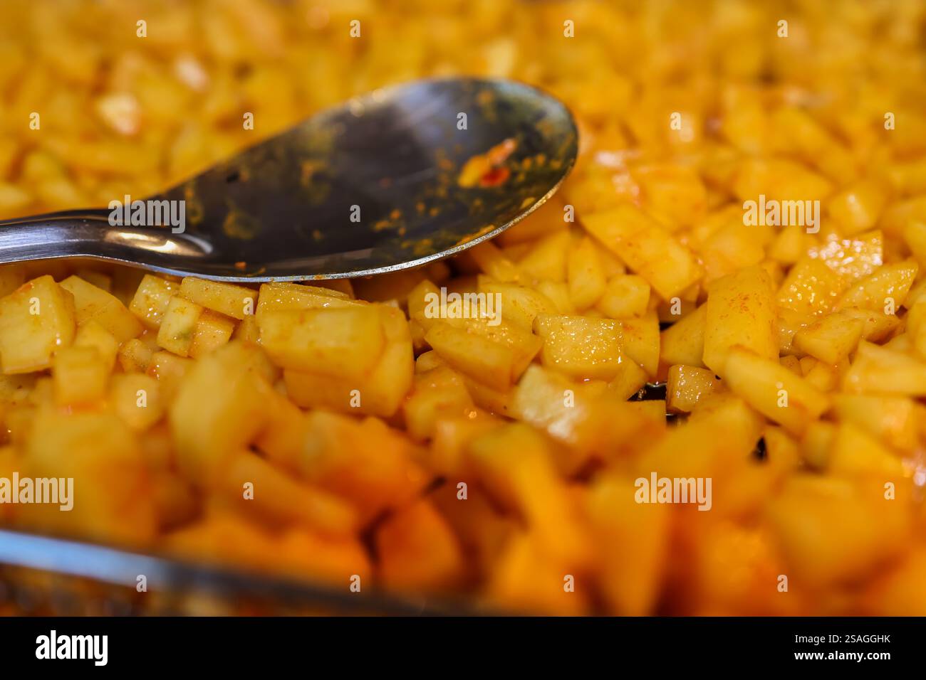 Fried spicy cut potatoes with curry powder close up view Stock Photo ...