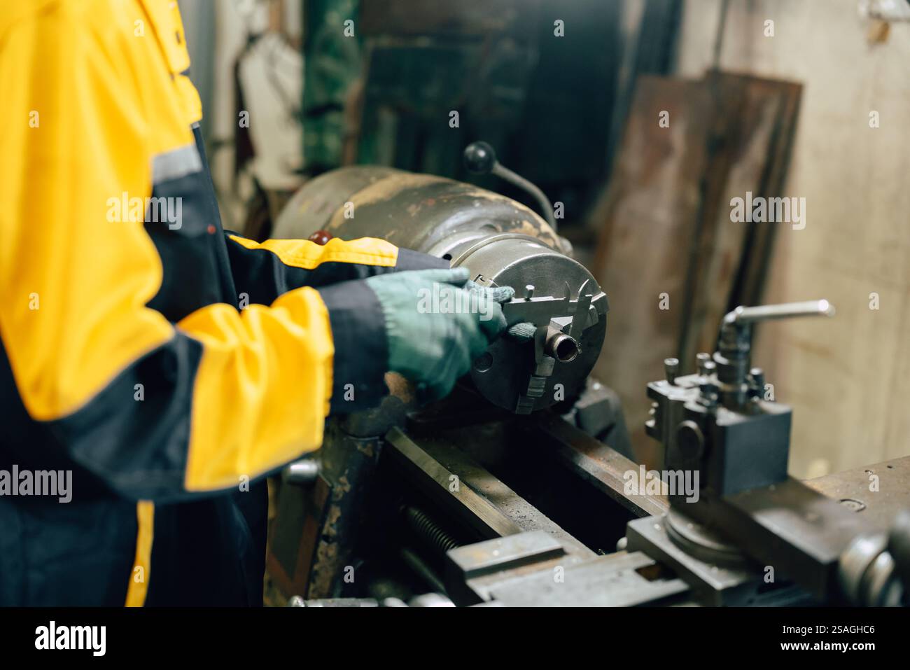 closeup worker hand using vernier caliper measuring part in lathe ...