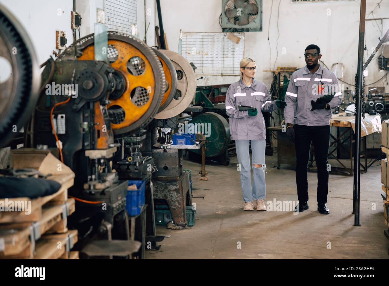 professional engineer officer team inspecting safety audit old machine in heavy industry factory ...