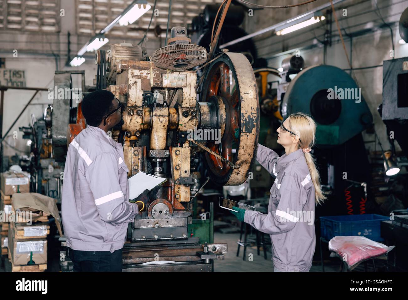 professional engineer officer team inspecting safety audit old machine in heavy industry factory ...