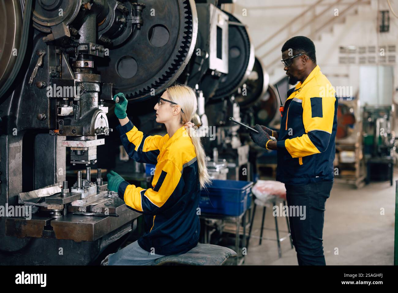 caucasian women worker working in heavy metal industry factory punching ...