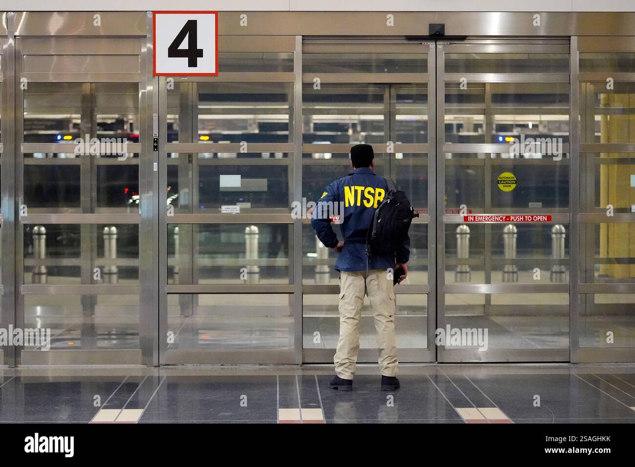 A member of the National Transportation Safety Board (NTSB) stands by a ...
