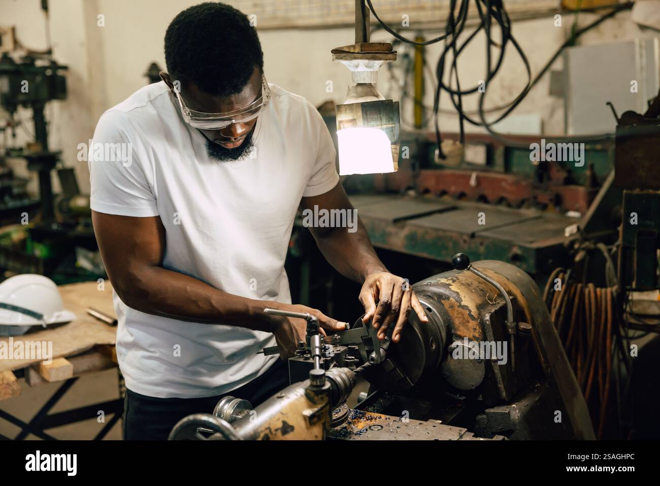 african black worker working in heavy metal industry factory with steel ...