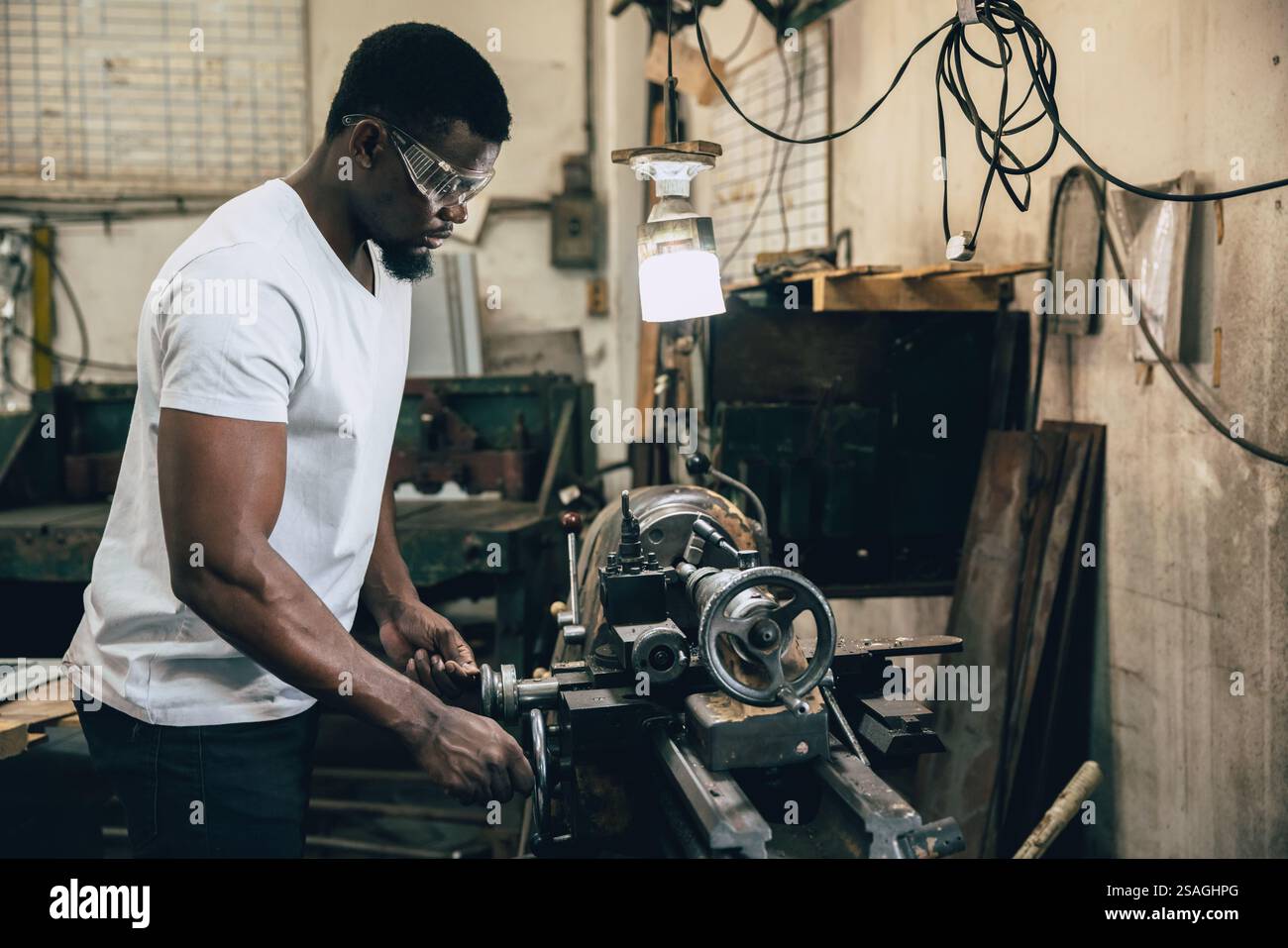 african black male professional worker working in heavy industry metal factory workshop using ...