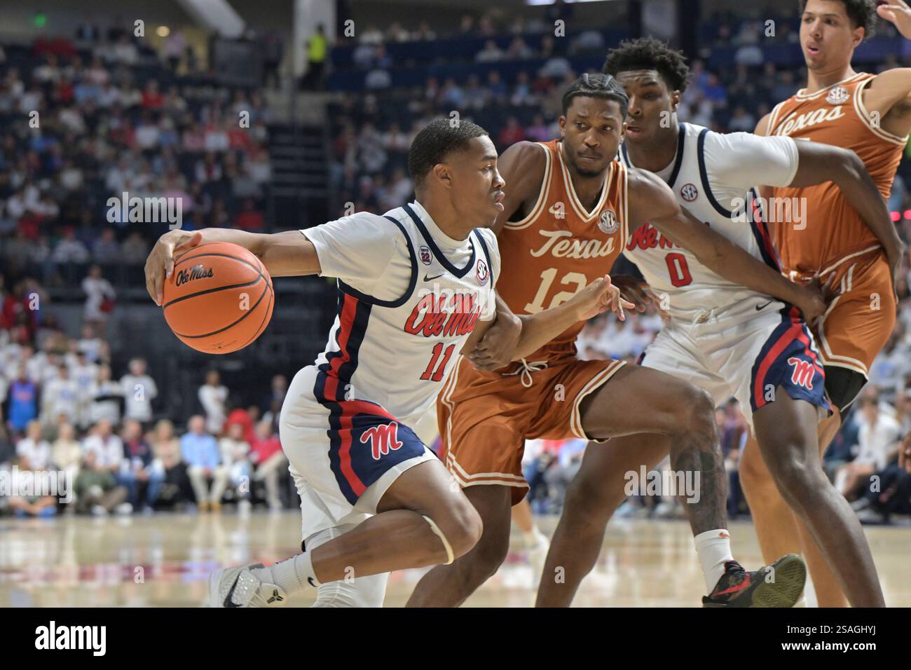 Mississippi guard Matthew Murrell (11) is defended by Texas guard ...