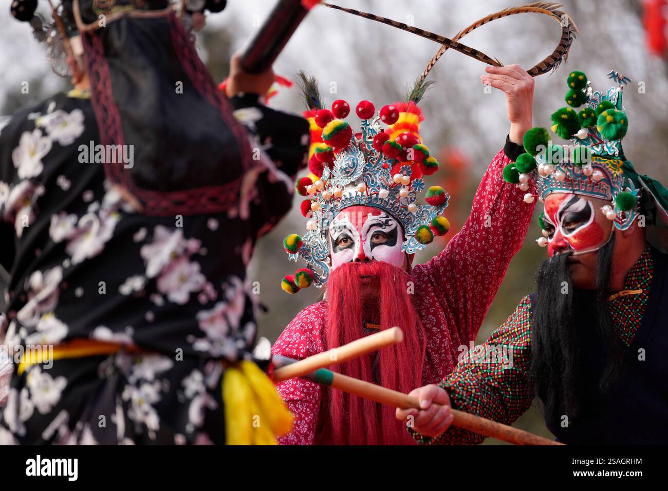 Chinese performers in traditional costumes on stage at the Longtan Park ...
