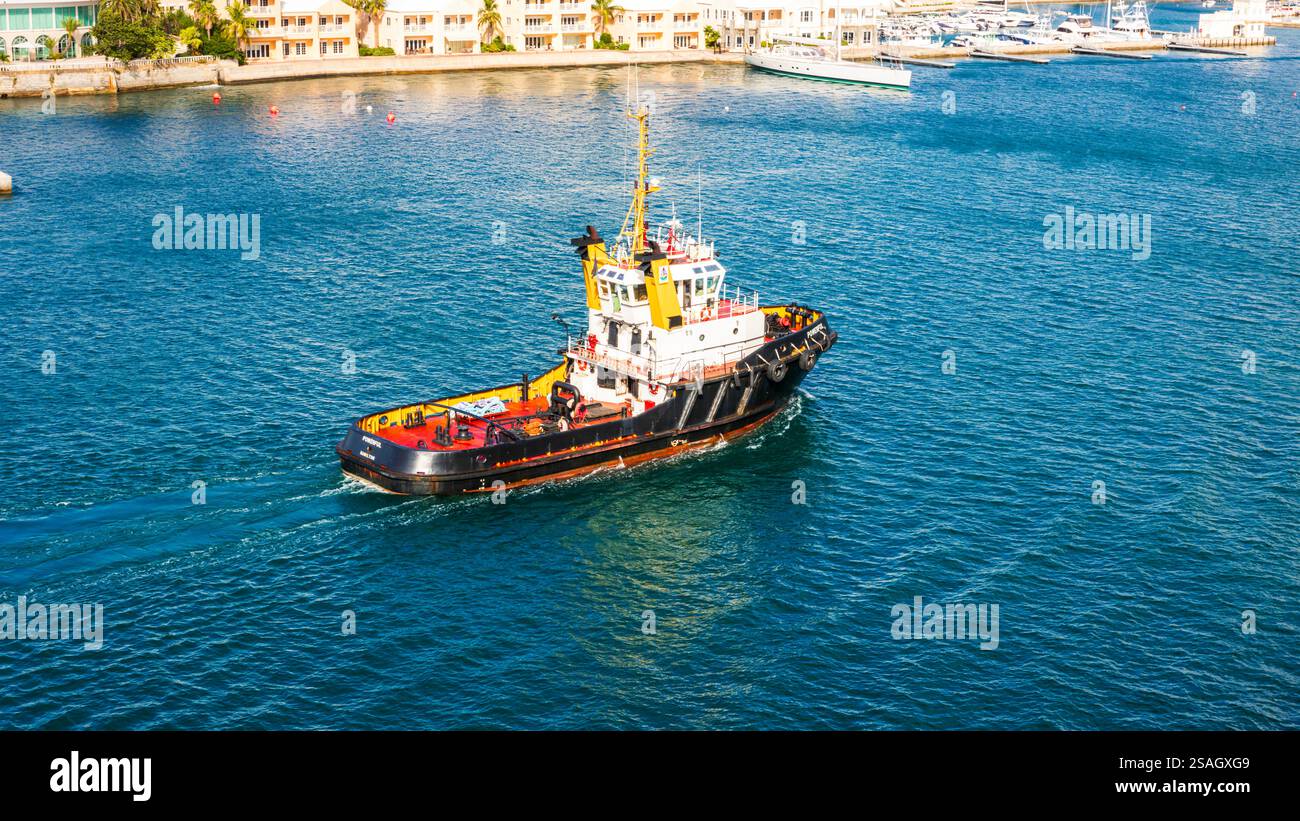 Tug boat in the Hamilton Harbor helping cruise ship to dock Stock Photo ...