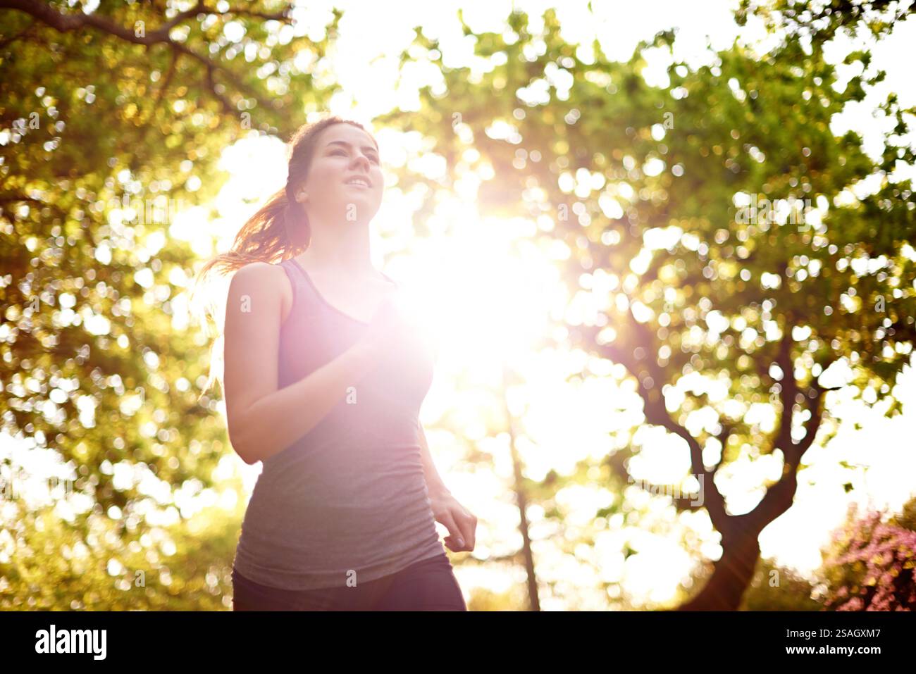 Running, fitness and woman with training, sunshine and runner with ...