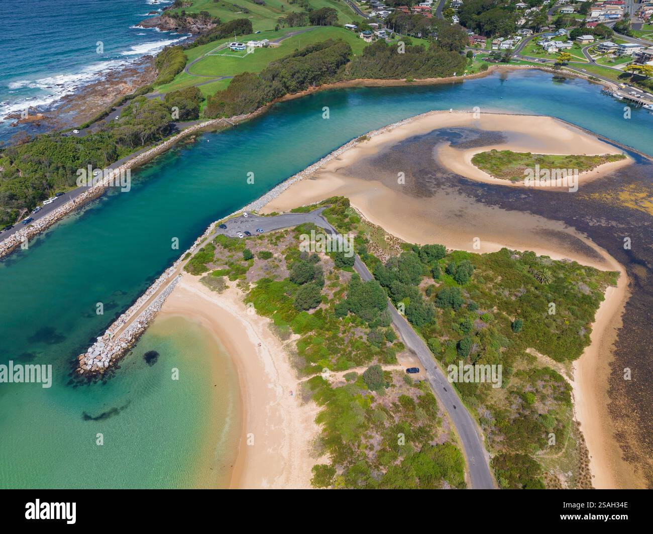 Aerial view of an inland river winding its way through coastal wetlands ...