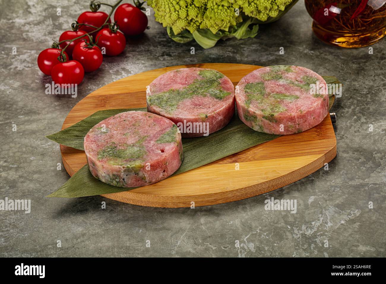 Raw Tuna medallion with broccoli cabbage Stock Photo - Alamy