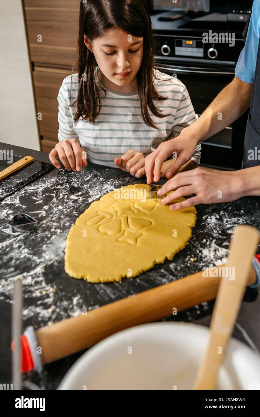 Brother and sister making cookies together for a party at home Stock ...