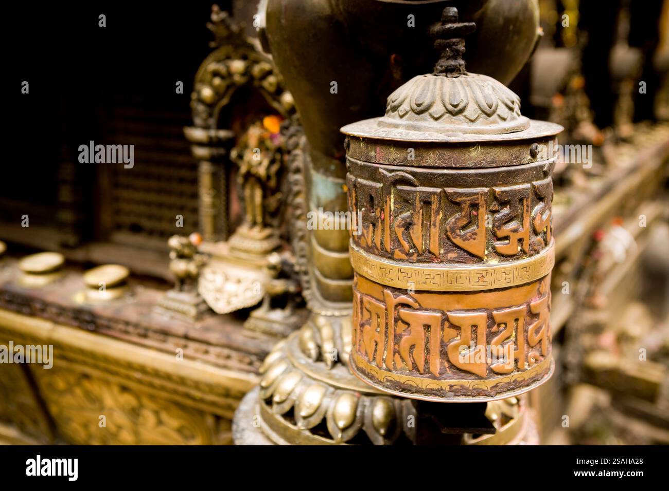 Bronze Tibetan prayer wheels or mani with the inscriptions in Sanskrit ...